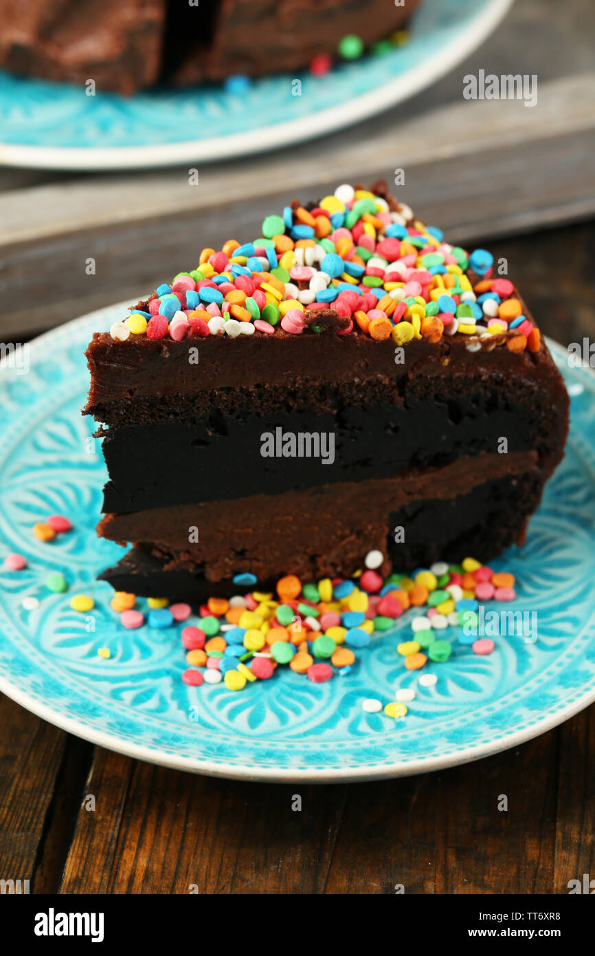 Chocolate cake with colorful sweet powder on table close-up Stock Photo ...