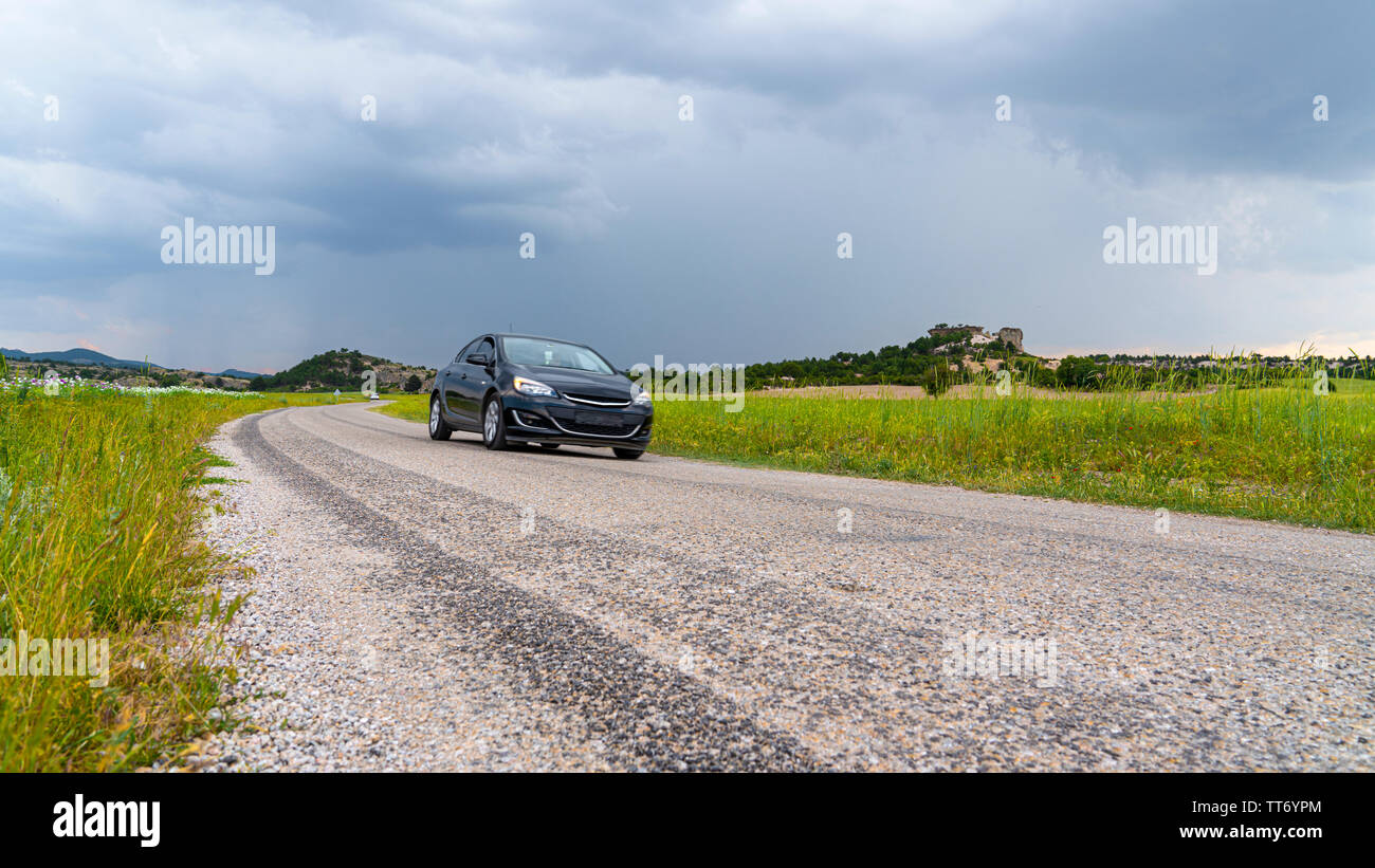 Car on the way among green fields in Phrygia Valley Natural Park (Frig ...