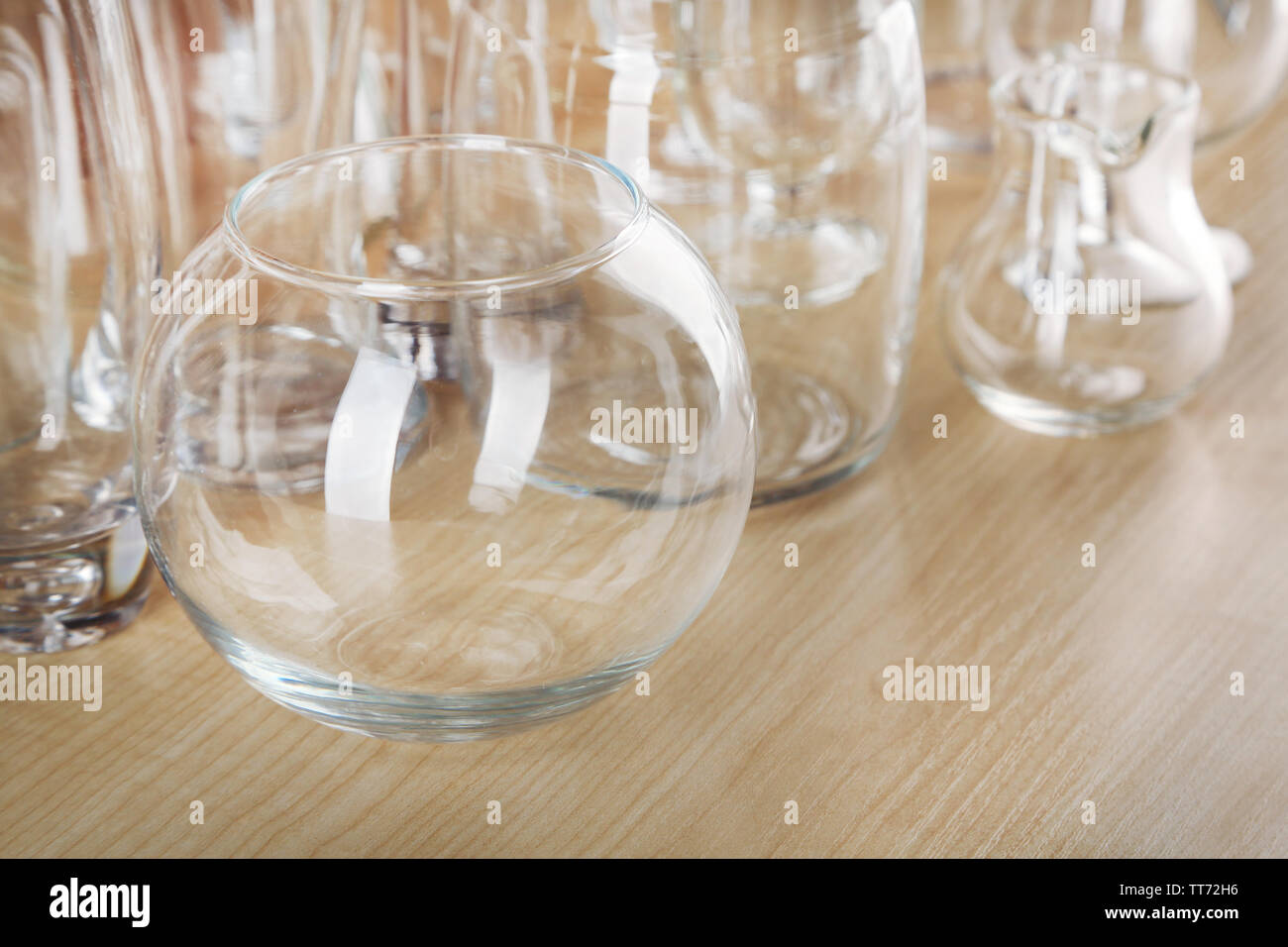 Different glassware on wooden table background Stock Photo - Alamy
