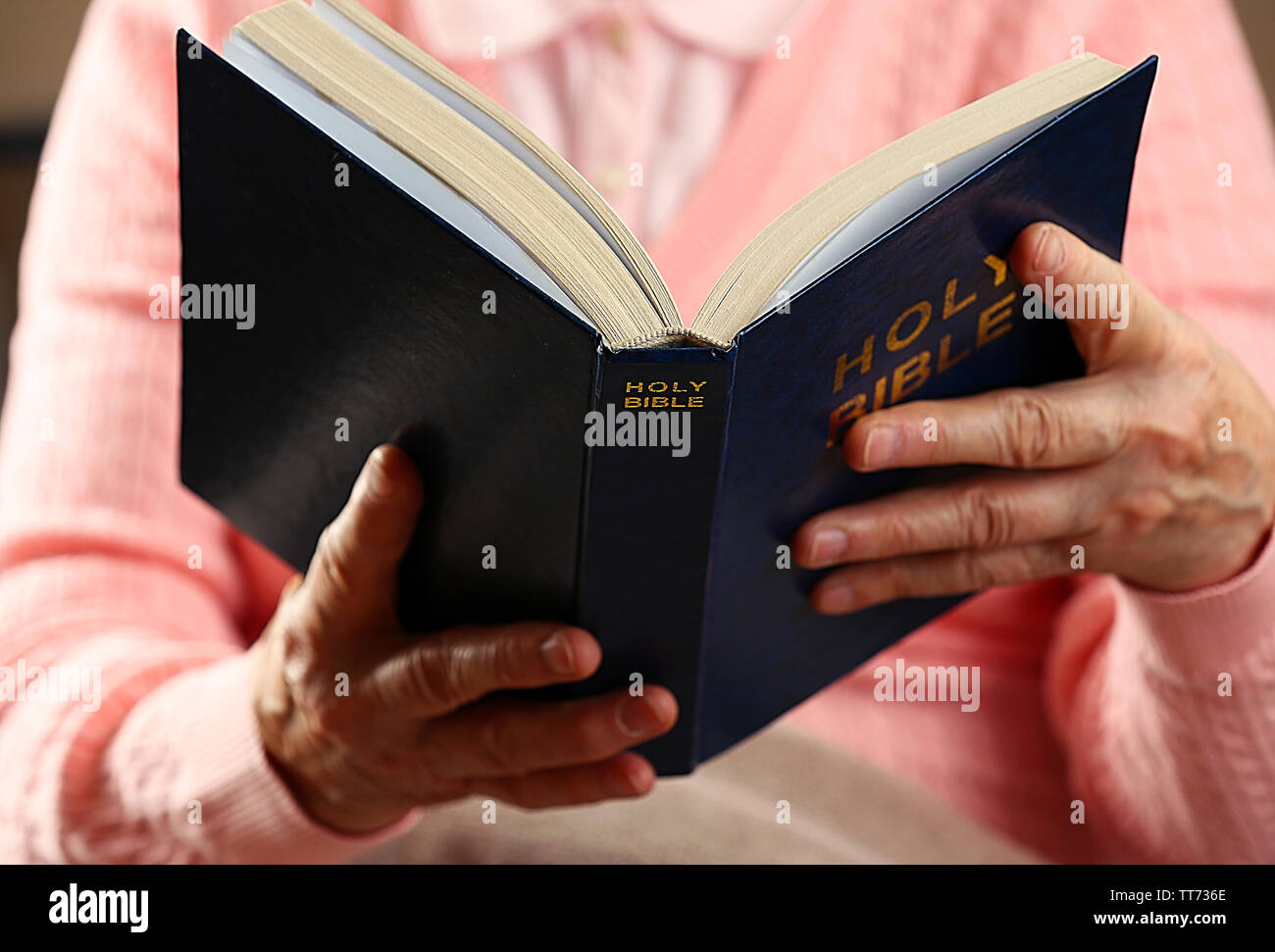 Old woman reading Bible, closeup Stock Photo - Alamy