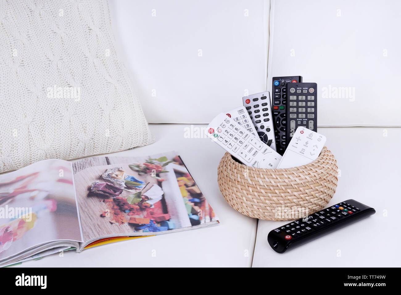 Many remote control devices on sofa Stock Photo - Alamy
