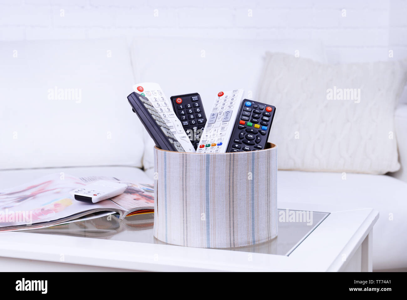 Many remote control devices on table in room Stock Photo - Alamy