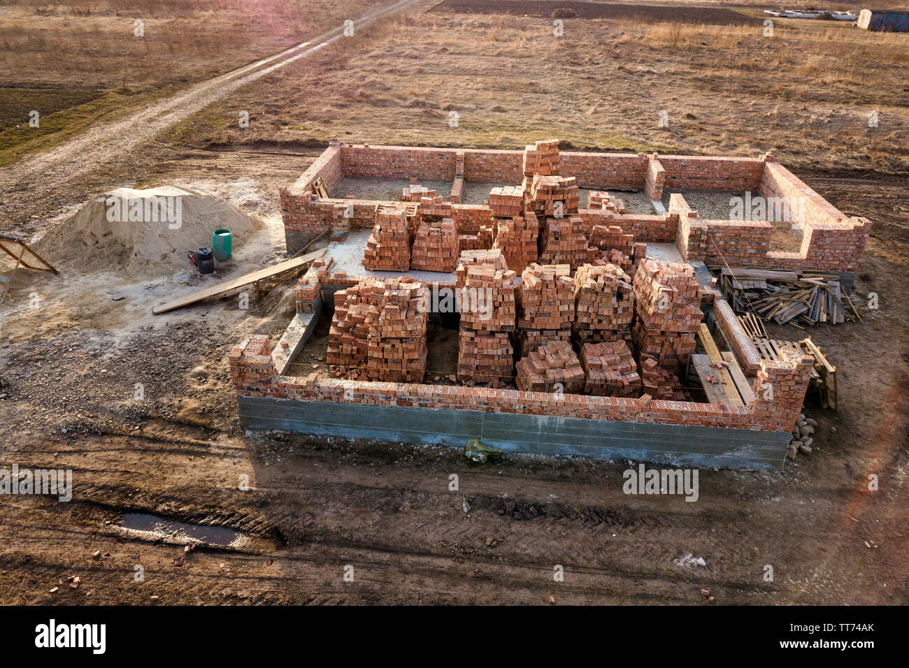Aerial view of building site. Trenches dug in ground and filled with ...