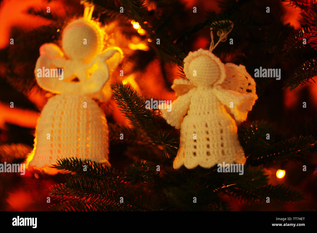 Knitted Christmas angels on Christmas lights background Stock Photo - Alamy