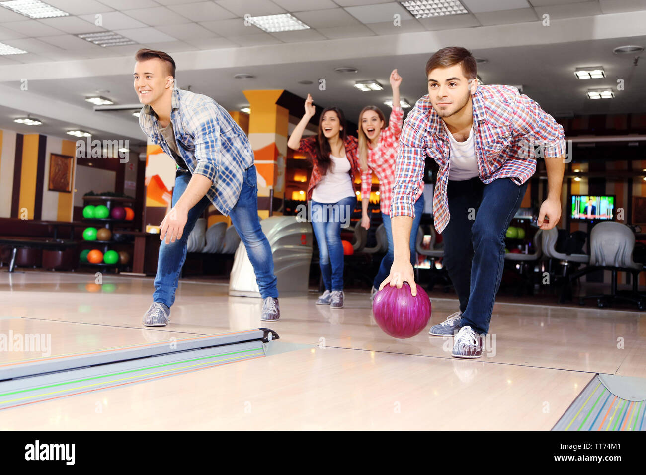 Happy friends playing bowling hi-res stock photography and images - Alamy