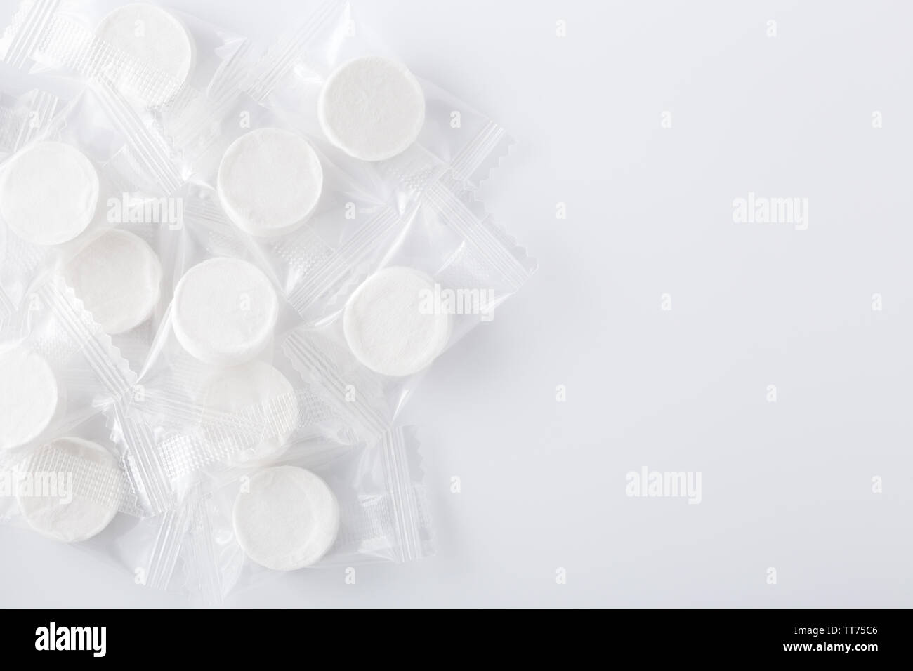 Compressed facial mask, dry sheet mask in package on white background ...