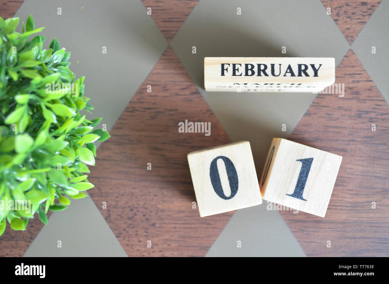 Date of February with leaf on diamond pattern table for background ...