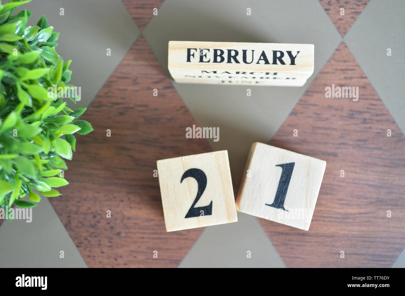 Date of February with leaf on diamond pattern table for background ...