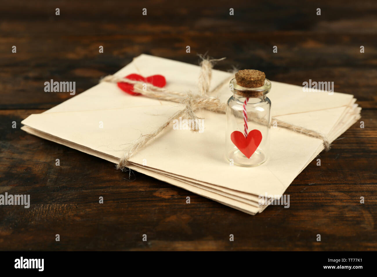 Stack of love letters with little bottle on rustic wooden table ...