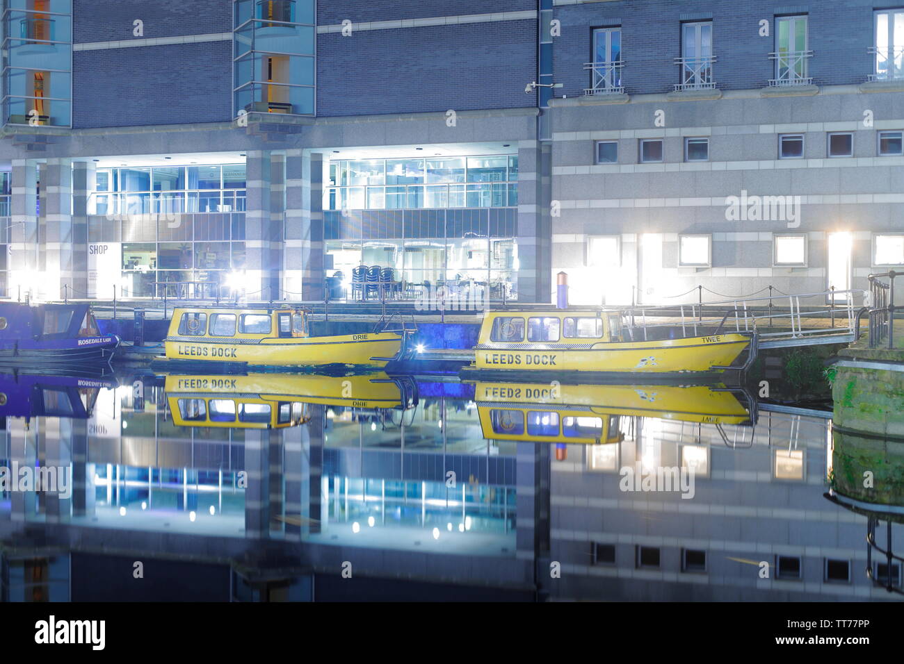 Reflections of Leeds Water Taxis moored besides the Royal Armouries ...