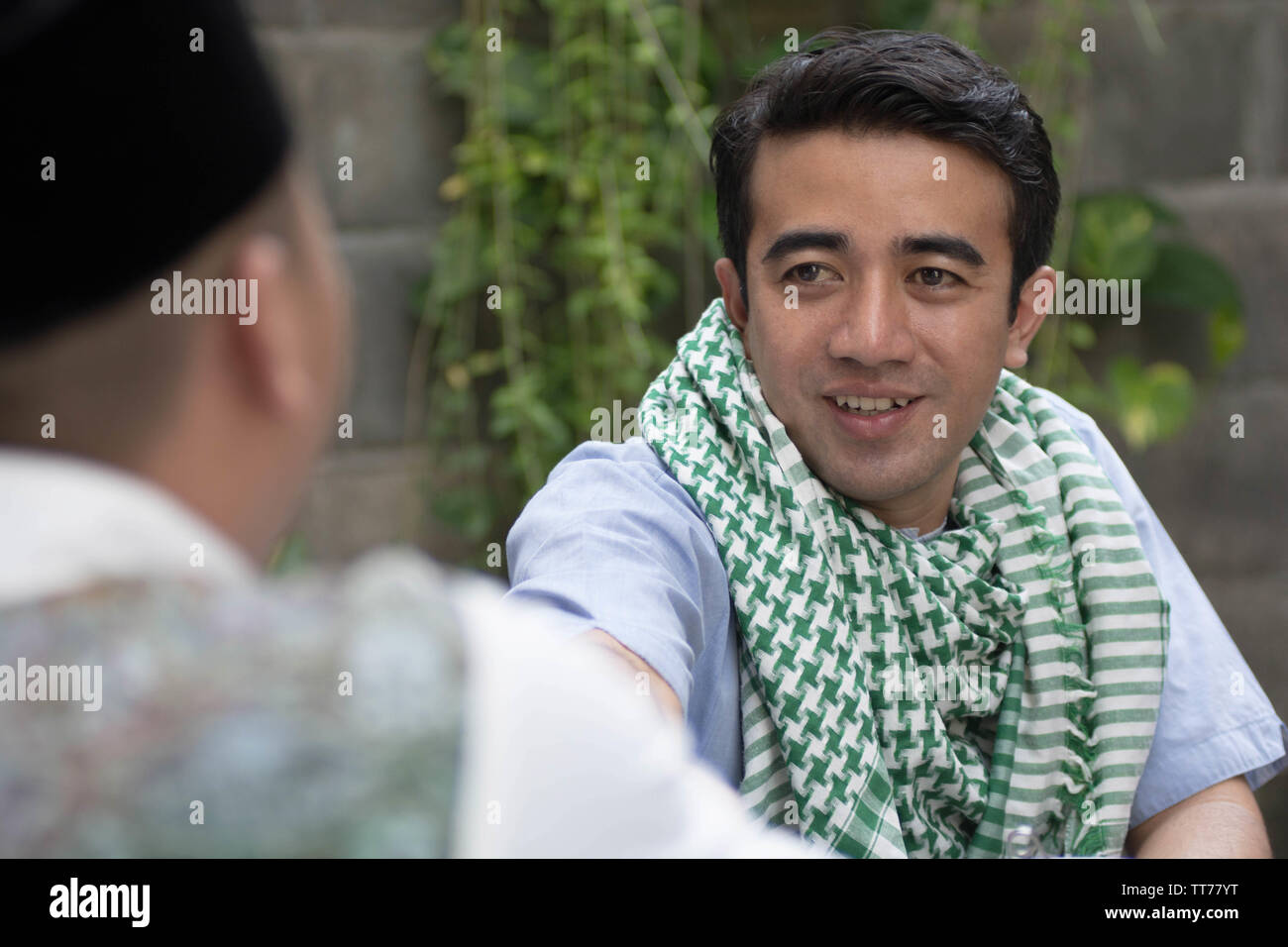 two man having hand shake at dining table during lunch and diner during ...