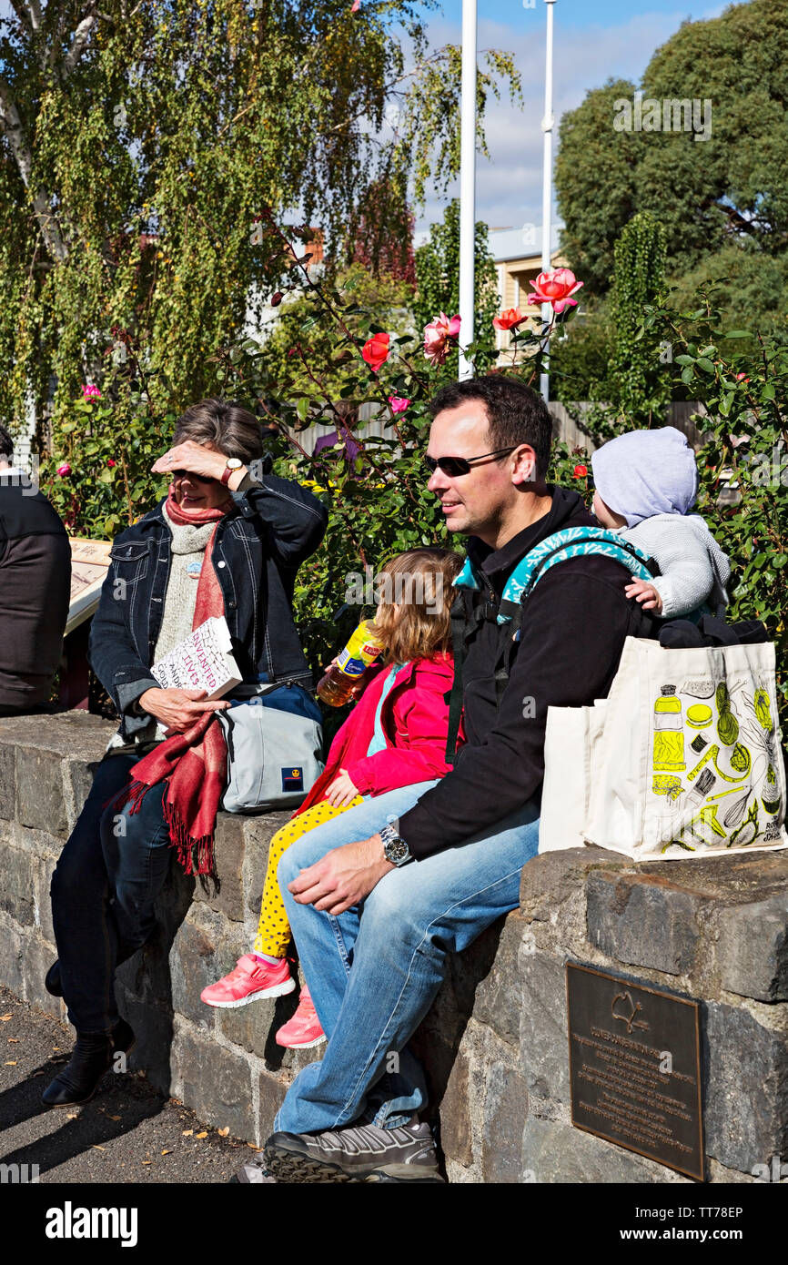 A family man relaxes at Clunes Booktown festival in the 1850`s gold ...
