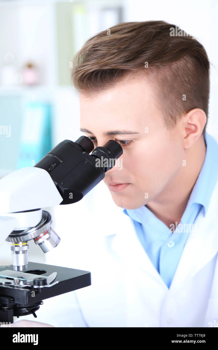 Male scientist using microscope in laboratory Stock Photo - Alamy