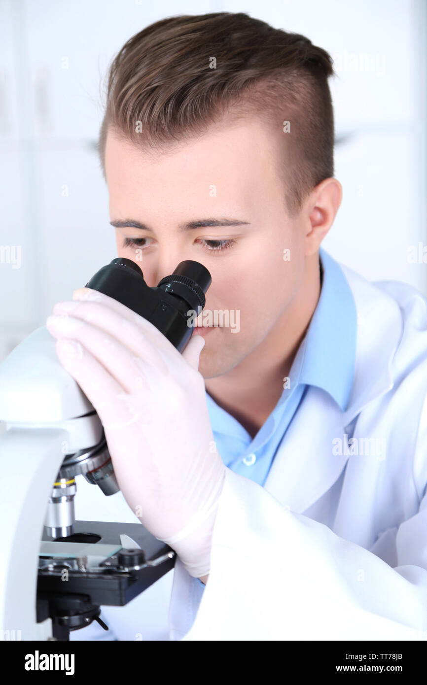 Male scientist using microscopes in laboratory Stock Photo - Alamy