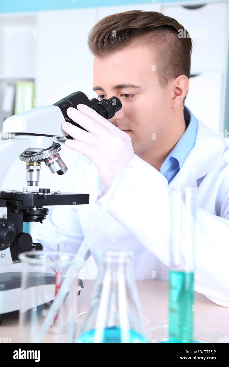 Male scientist using microscopes in laboratory Stock Photo - Alamy