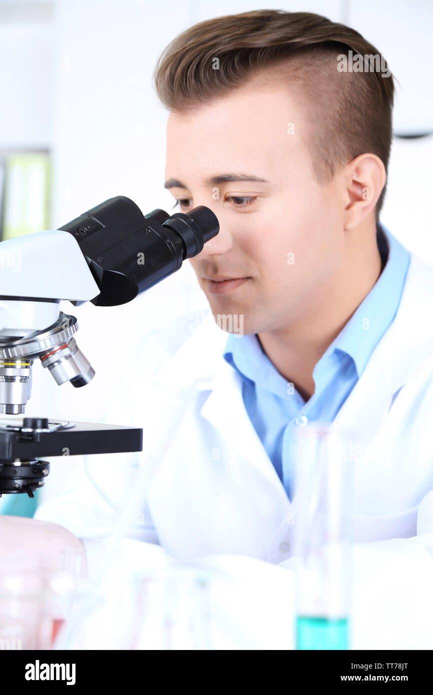 Male scientist using microscope in laboratory Stock Photo - Alamy