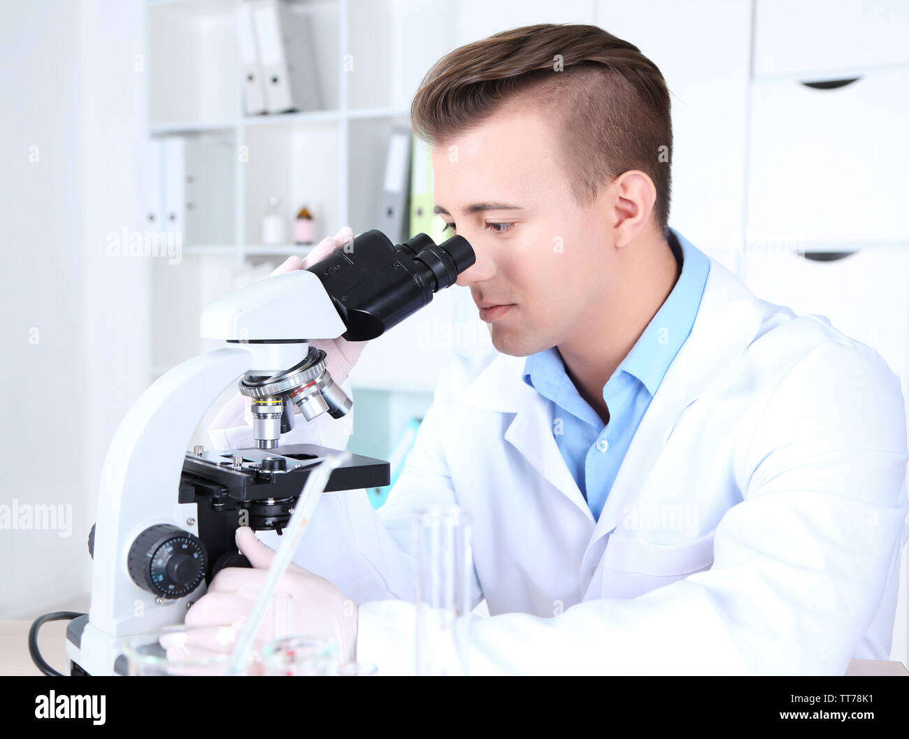 Male scientist using microscope in laboratory Stock Photo - Alamy