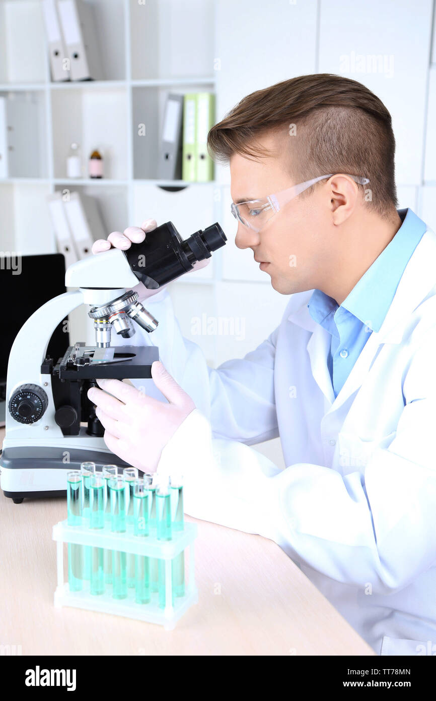Male scientist using microscope in hi-res stock photography and images ...
