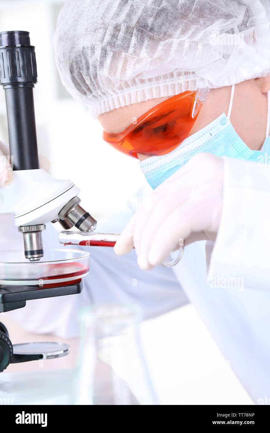 Male scientist using microscope in laboratory Stock Photo - Alamy