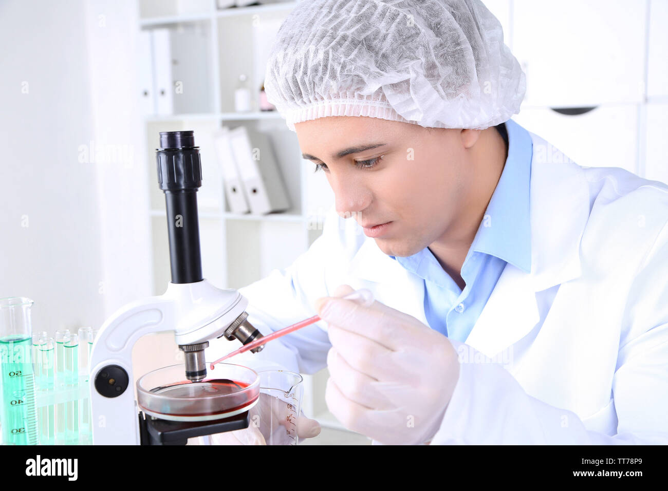 Male scientist using microscope in laboratory Stock Photo - Alamy