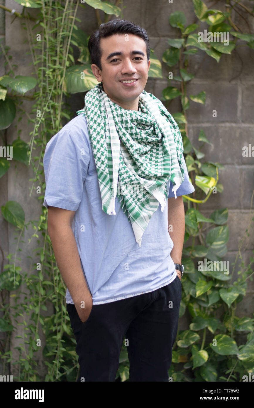 portrait of A muslim man stand and pose in front of the camera at ...