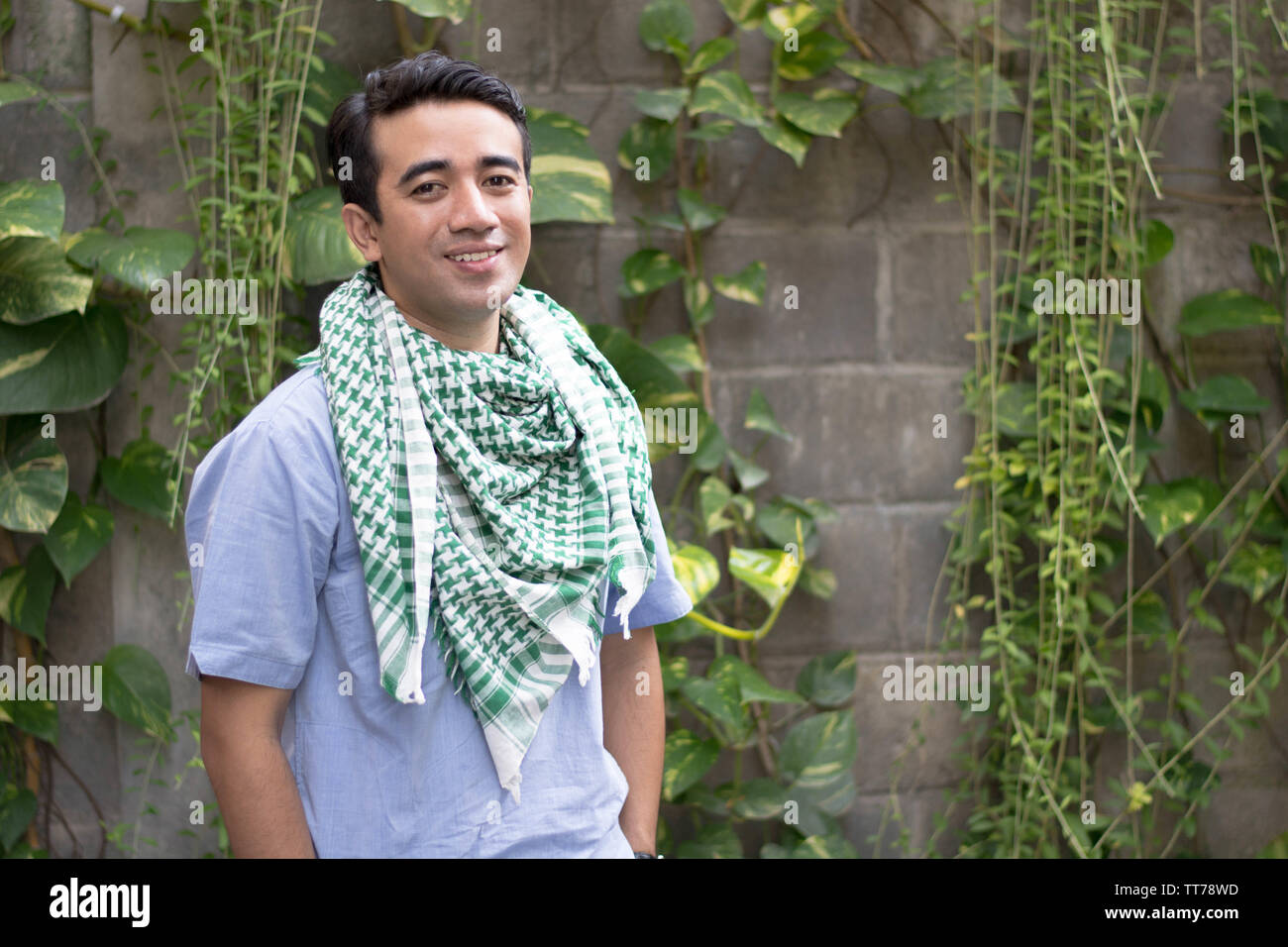 portrait of A muslim man stand and pose in front of the camera at ...