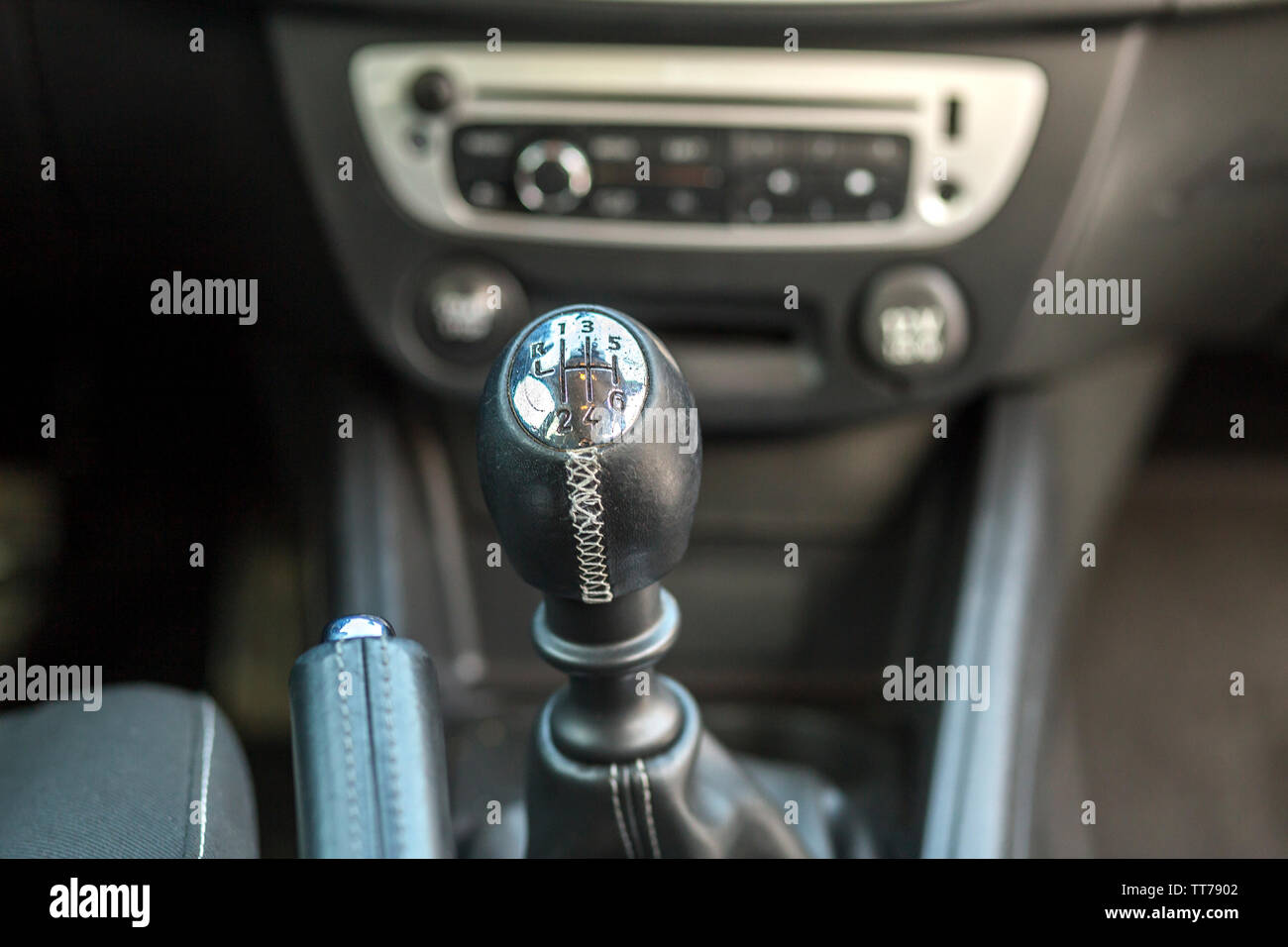Luxurious car black leather interior. Close-up detail of handbrake ...