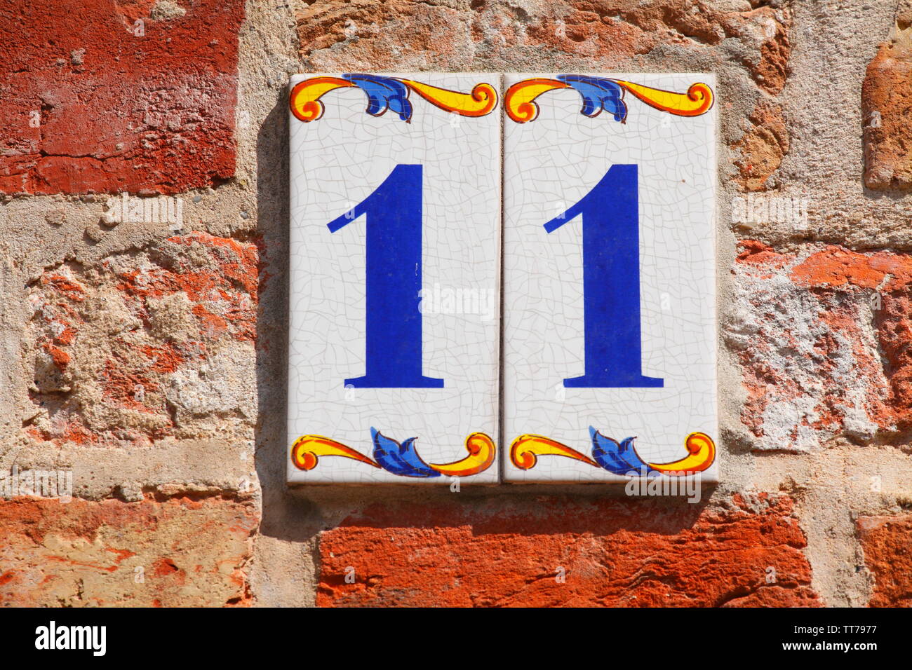 colorful house number plate number 11, colorful tile on brick wall ...