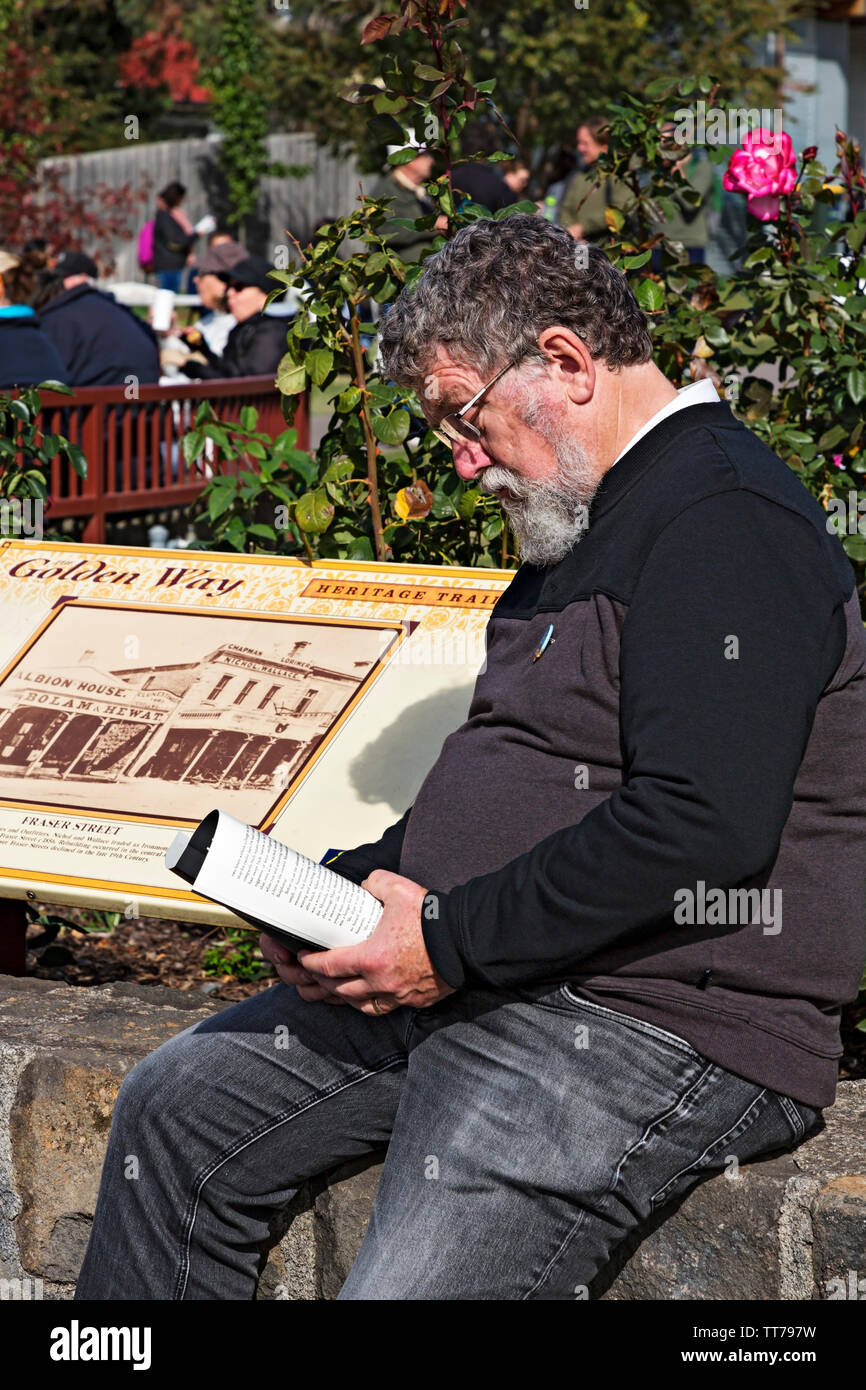 A man reads a book at Clunes Booktown festival in the 1850`s gold ...