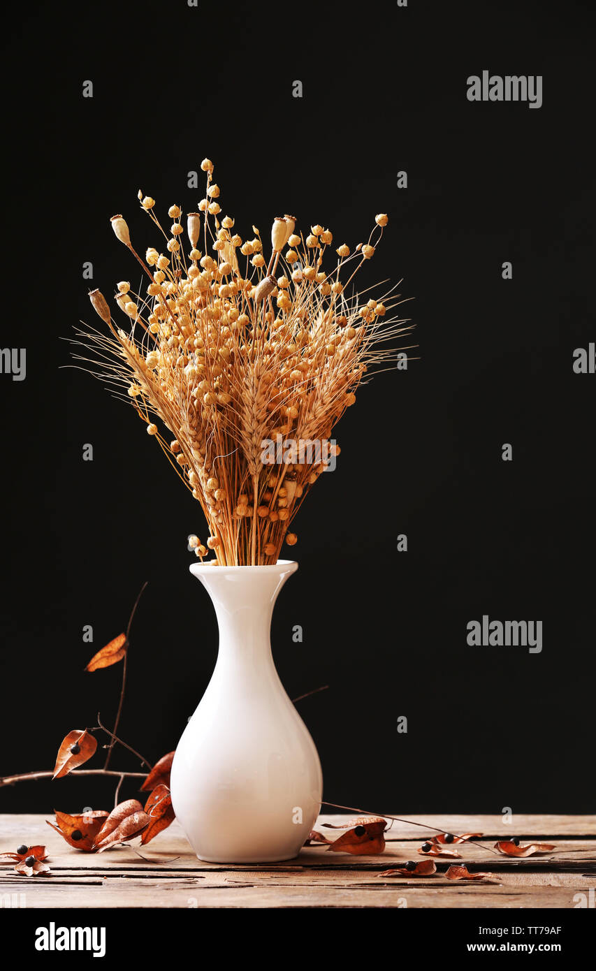 Dried wheat in vase on dark background Stock Photo - Alamy