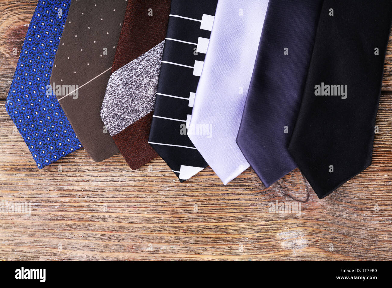 Different Ties on wooden planks background Stock Photo - Alamy