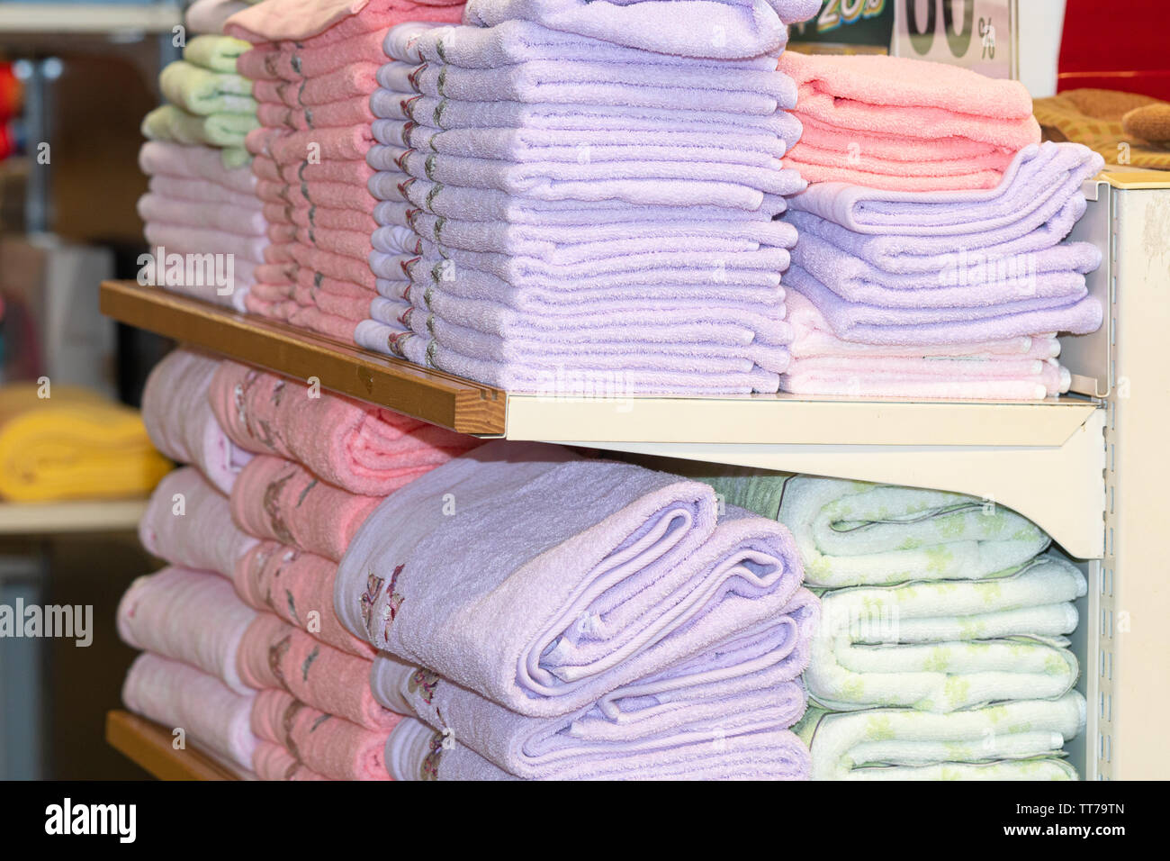 Stack of the multicolored towels on shelf Stock Photo - Alamy