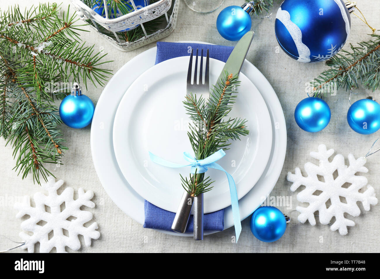 Stylish blue and white Christmas table setting on grey tablecloth ...