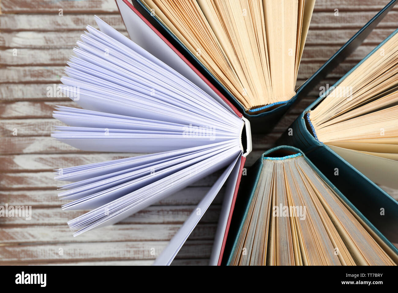 Group of books on wooden planks background, top view Stock Photo - Alamy