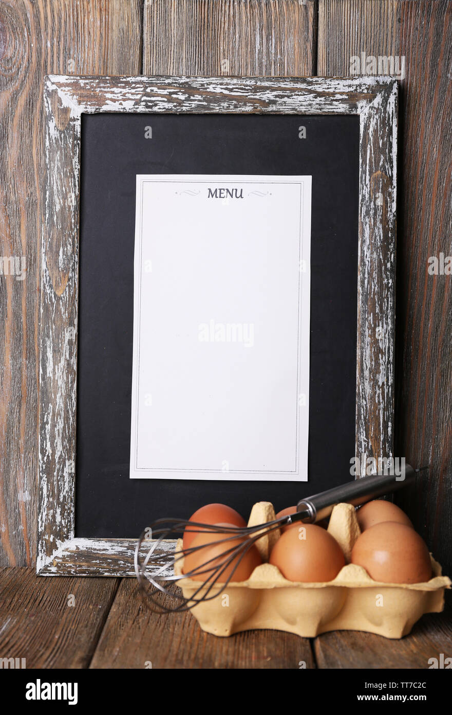 Menu board with eggs on rustic wooden planks background Stock Photo - Alamy