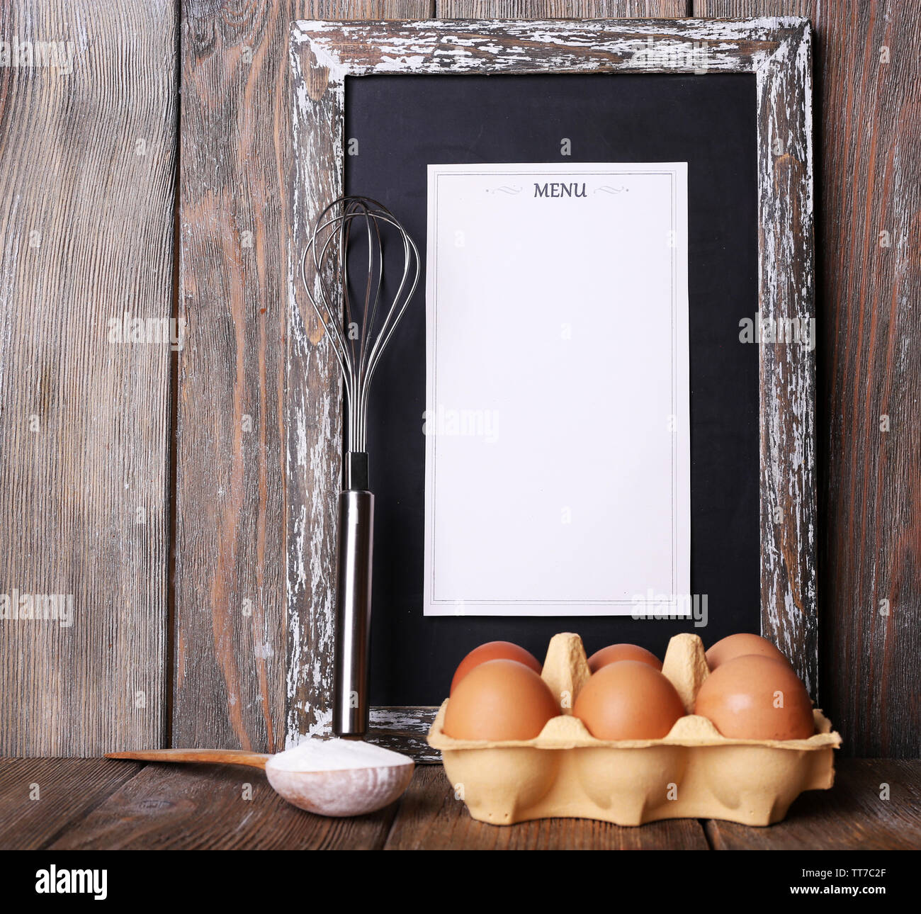 Menu board with eggs on rustic wooden planks background Stock Photo - Alamy