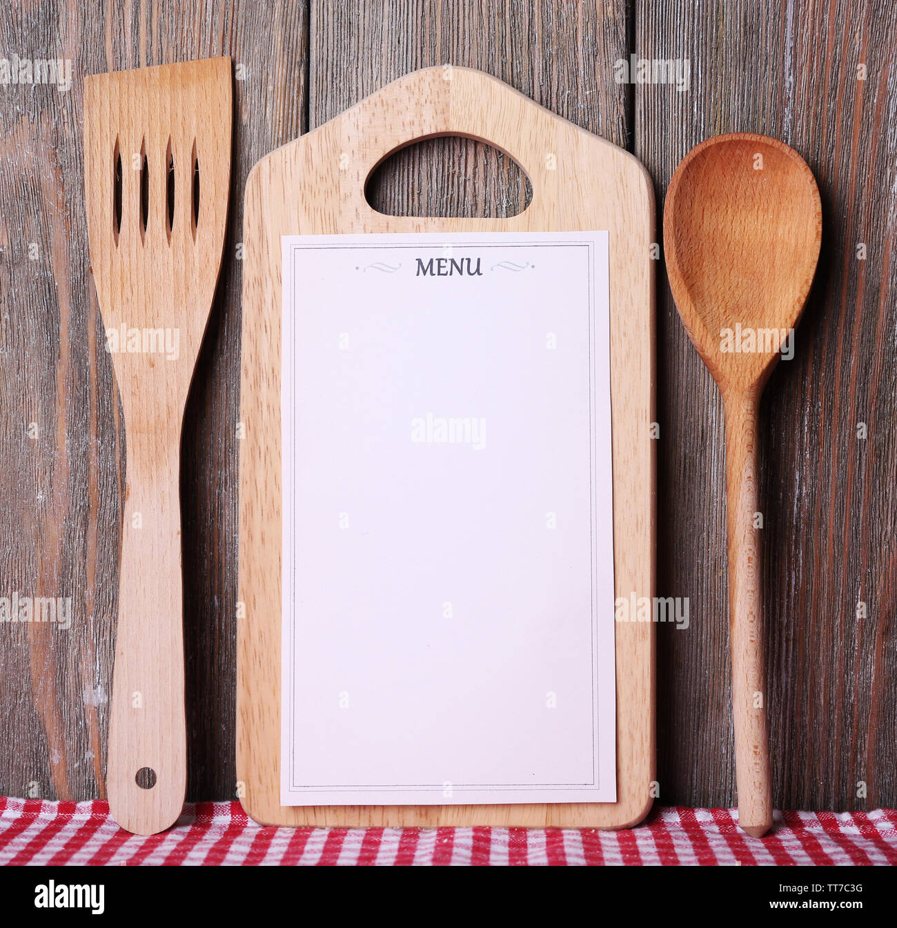 Cutting board with menu sheet of paper, with cherry tomatoes and ...