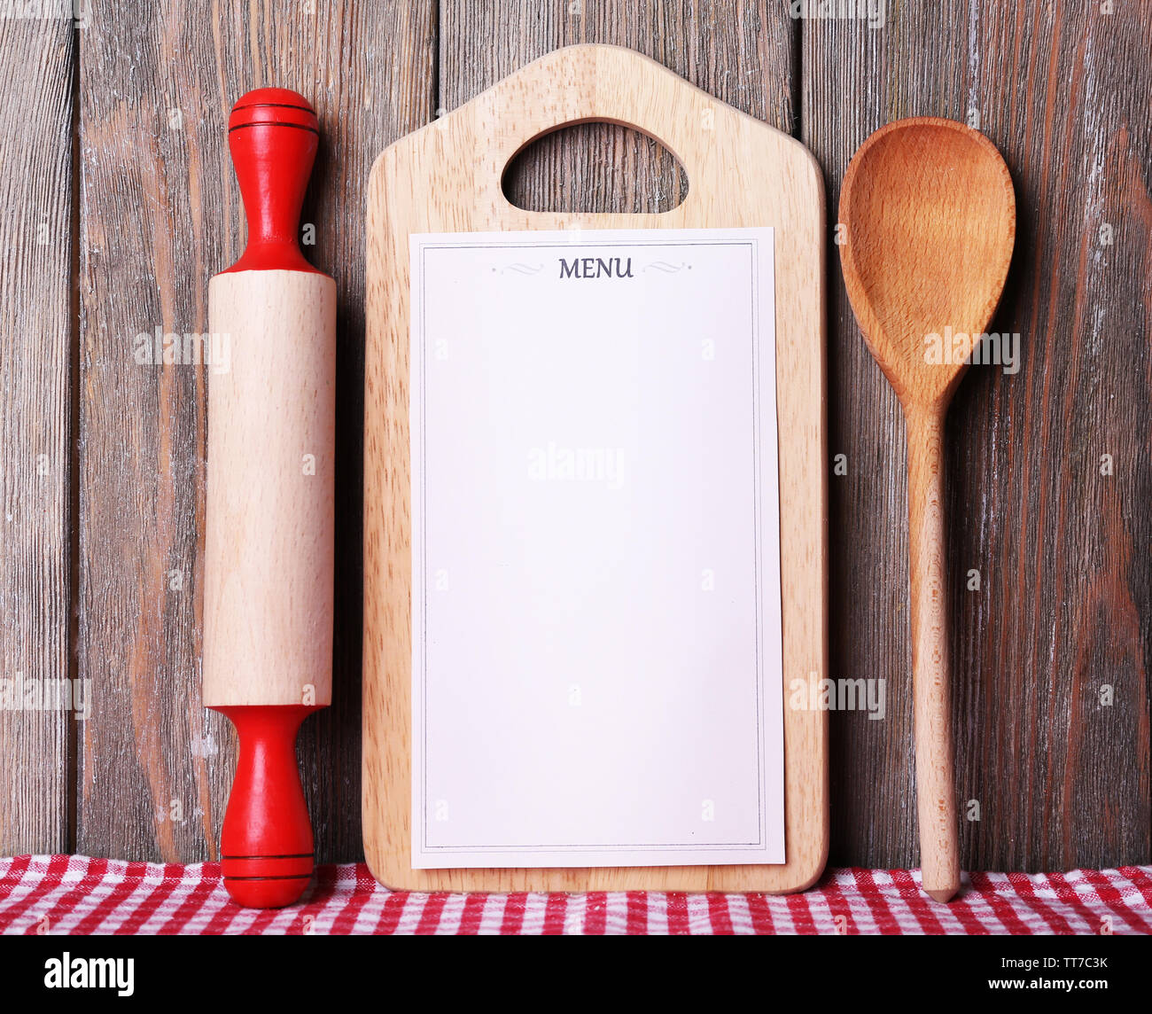 Cutting board with menu sheet of paper, with cherry tomatoes and ...