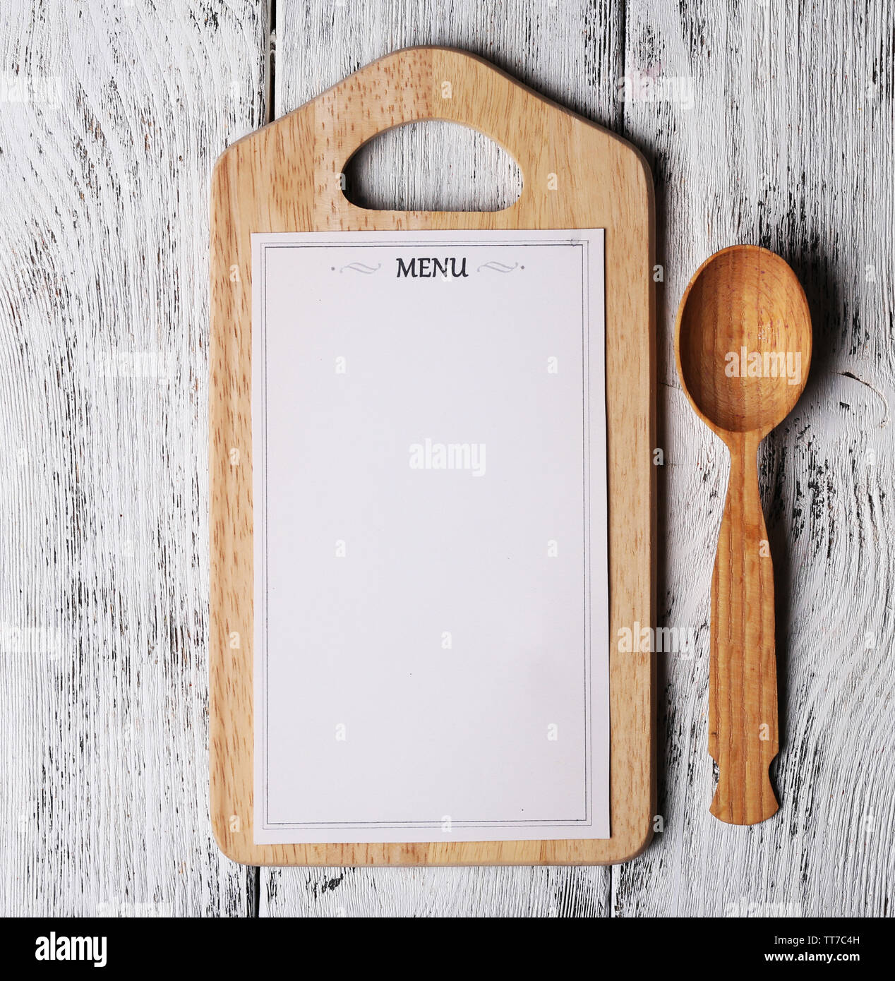 Cutting board with menu sheet of paper on color wooden background Stock ...