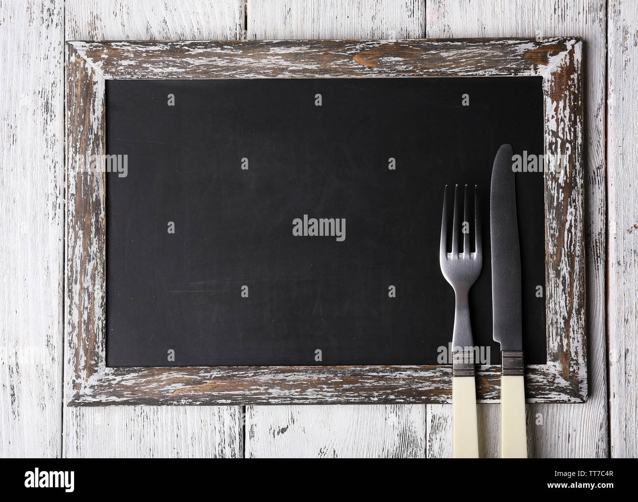 Menu board on color wooden planks background Stock Photo - Alamy