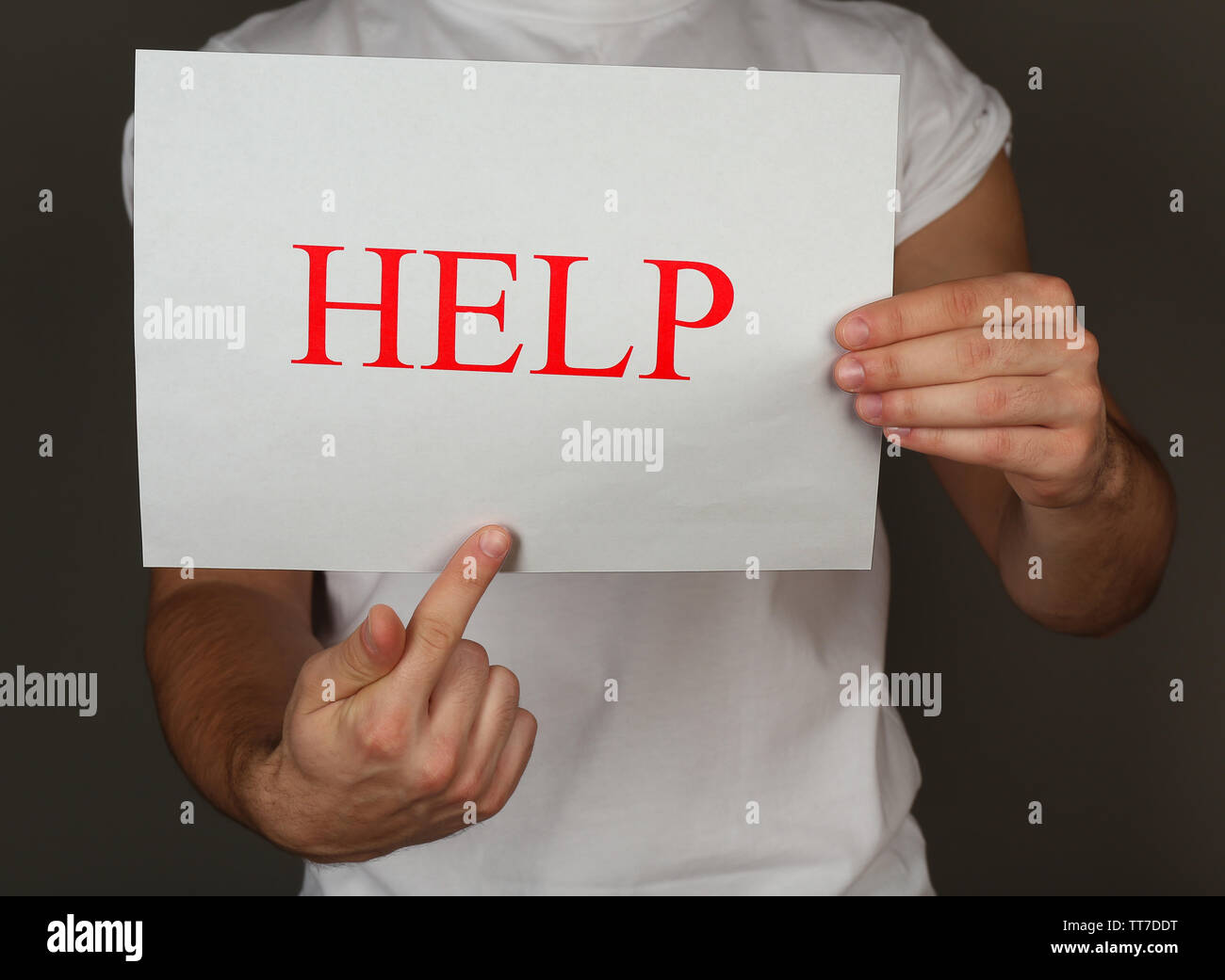 Sheet of paper with Help sign in male hands on dark background Stock ...