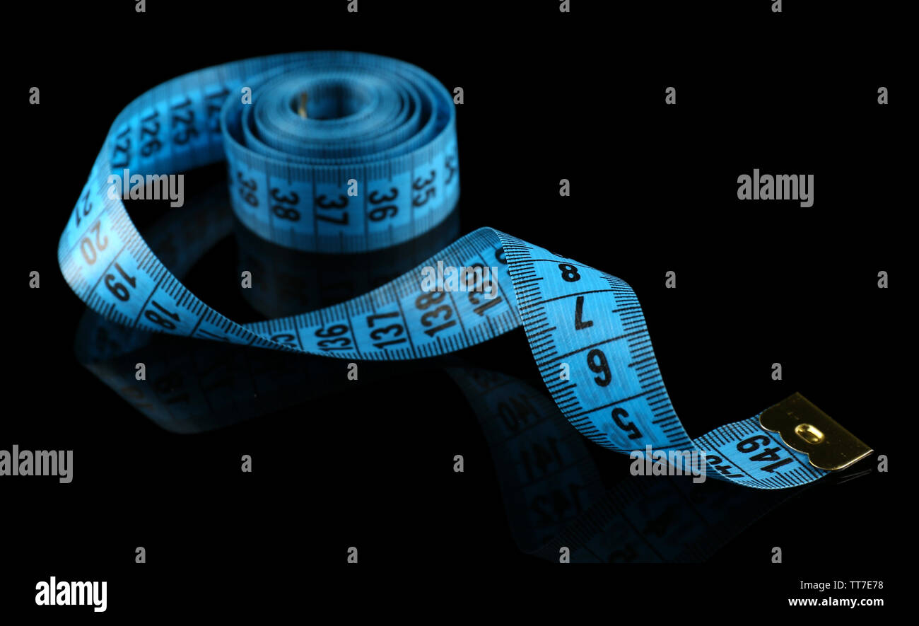 Measuring tape on black background Stock Photo - Alamy