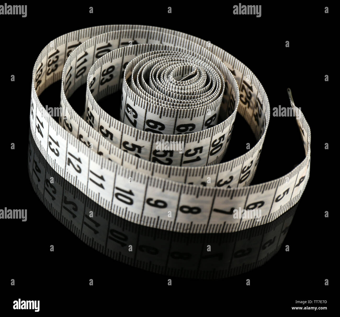 Measuring tape on black background Stock Photo - Alamy