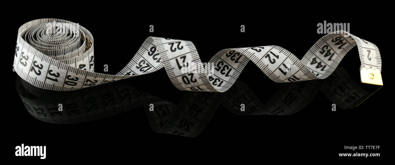 Measuring tape on black background Stock Photo - Alamy