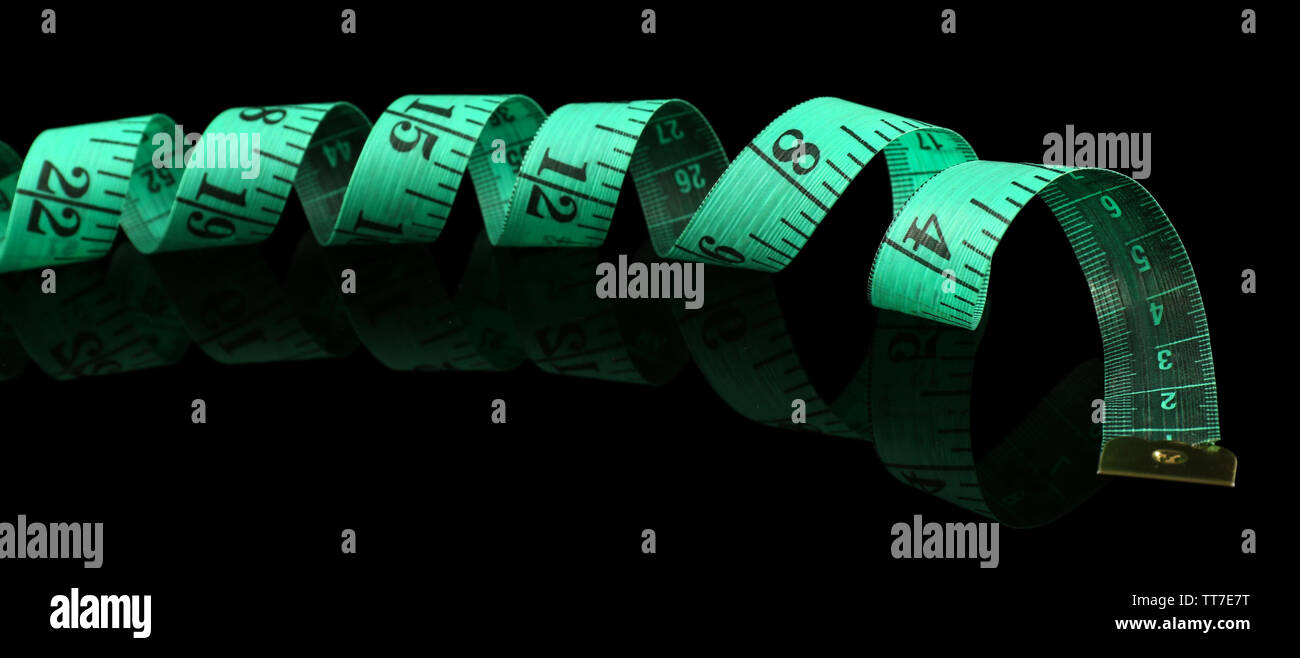 Measuring tape on black background Stock Photo - Alamy