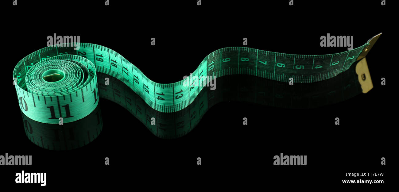 Measuring tape on black background Stock Photo - Alamy