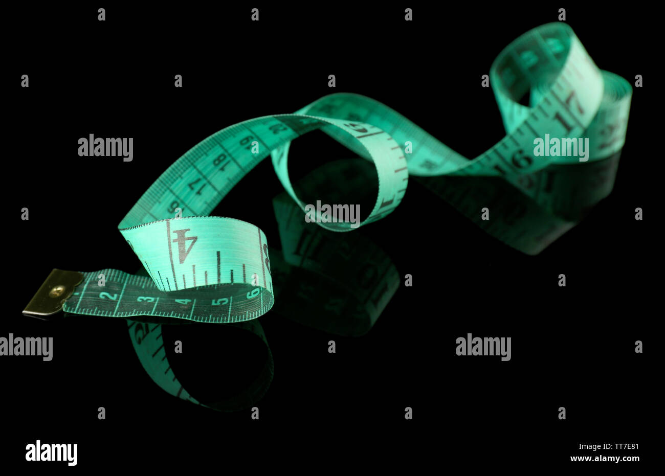Measuring tape on black background Stock Photo - Alamy