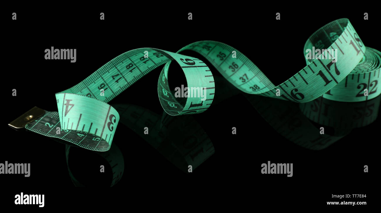 Measuring tape on black background Stock Photo - Alamy