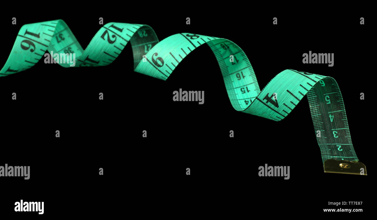 Measuring tape on black background Stock Photo - Alamy