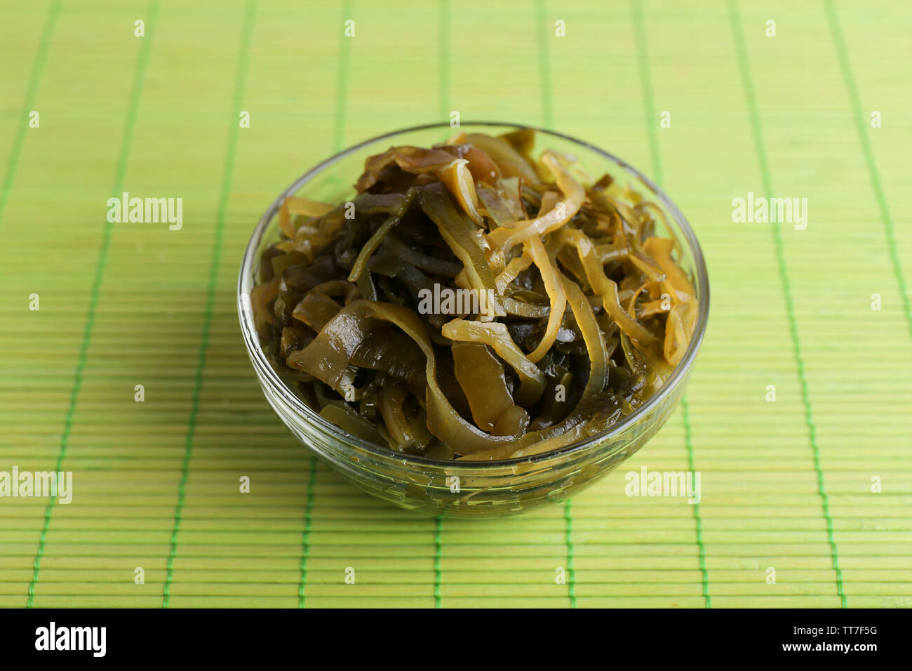Seaweed in glass bowl on bamboo mat background Stock Photo - Alamy